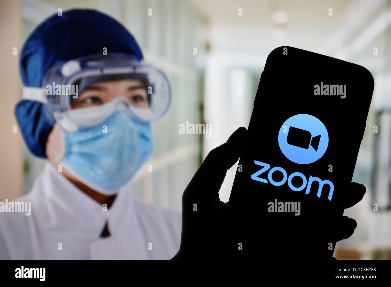 In this photo illustration a Zoom online communicator app logo seen ...