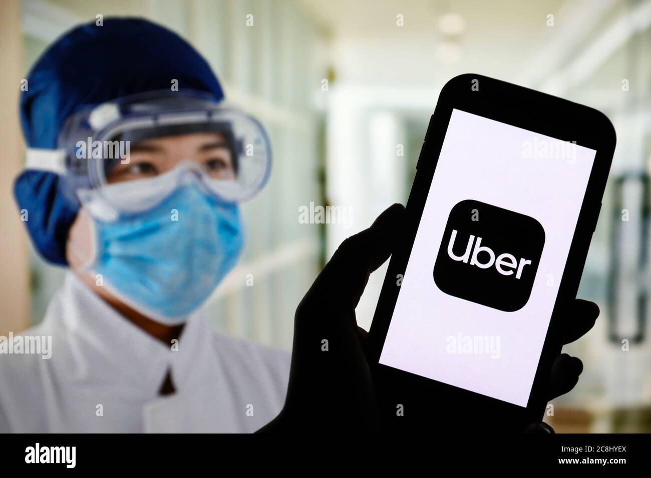 In this photo illustration an Uber app logo seen displayed on a ...