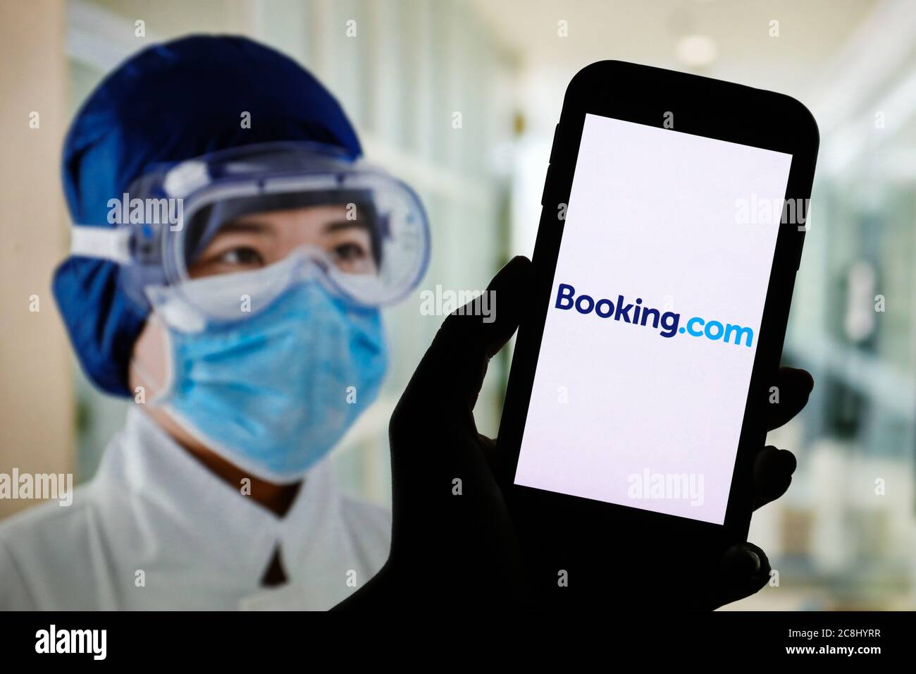 In this photo illustration a Booking.com logo seen displayed on a ...