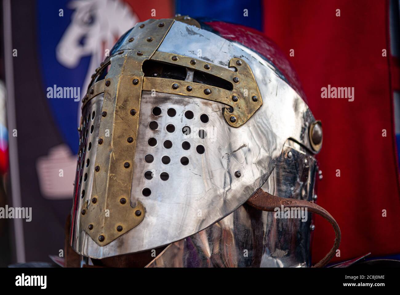 Shiny silver medieval iron knight helmet with a golden cross, full of ...