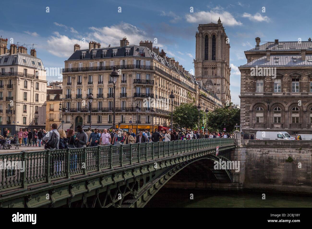Crossing a bridge in Paris in view of Notre Dame cathedral Stock Photo ...
