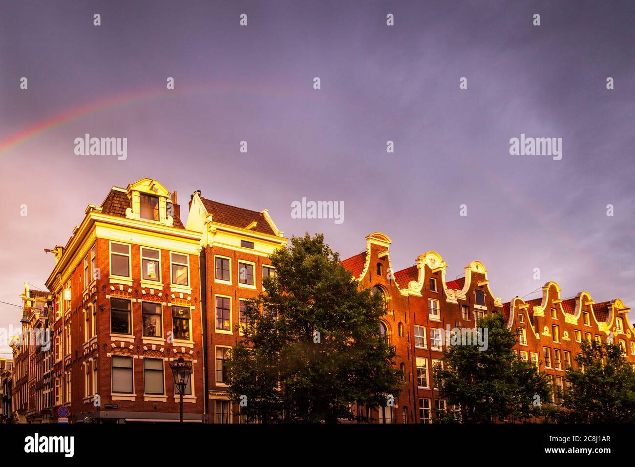 Rainbow over row houses in Amsterdam Stock Photo - Alamy