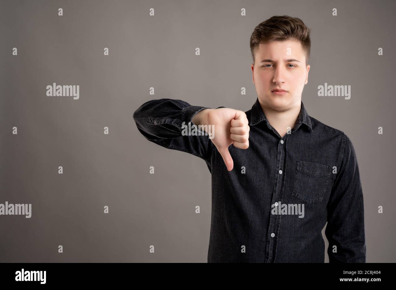 Portrait of serious stylish attractive man dressed with a casual black ...