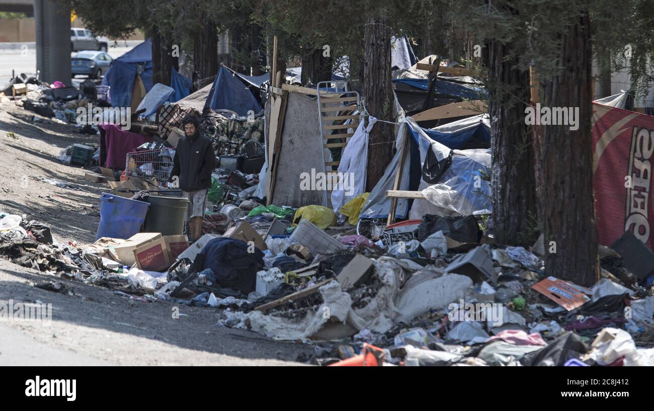 San Jose, United States. 25th July, 2020. A man stands in a homeless ...