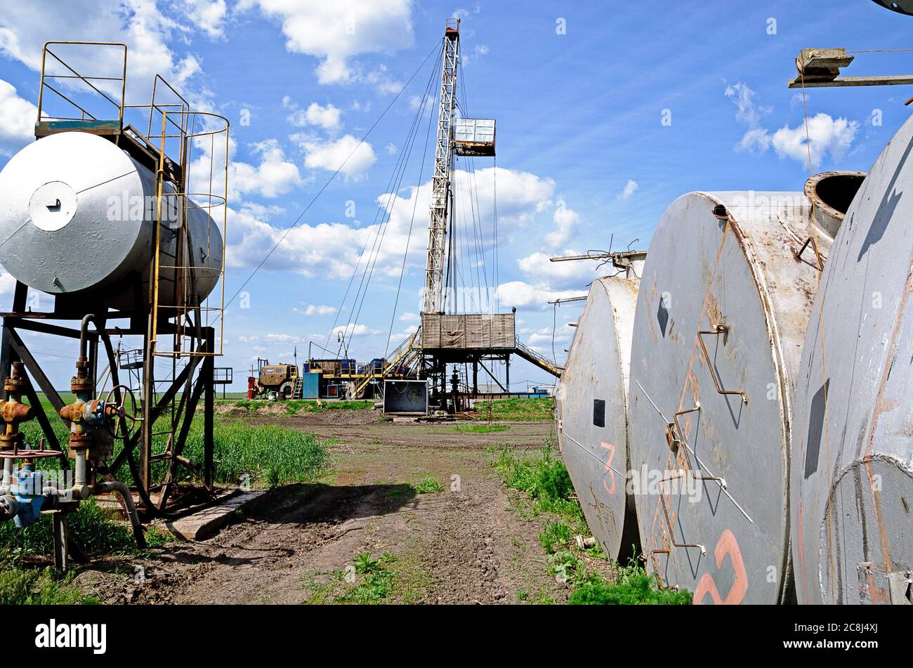 mounted workover unit on a gas well, trip tank and tanks for storing ...