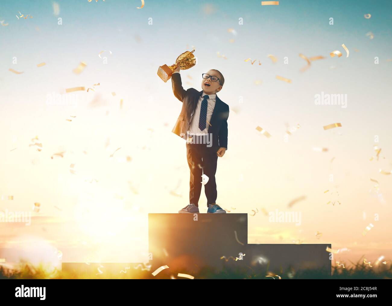 Little child is winner. Kid on sunset background. Smart power concept ...