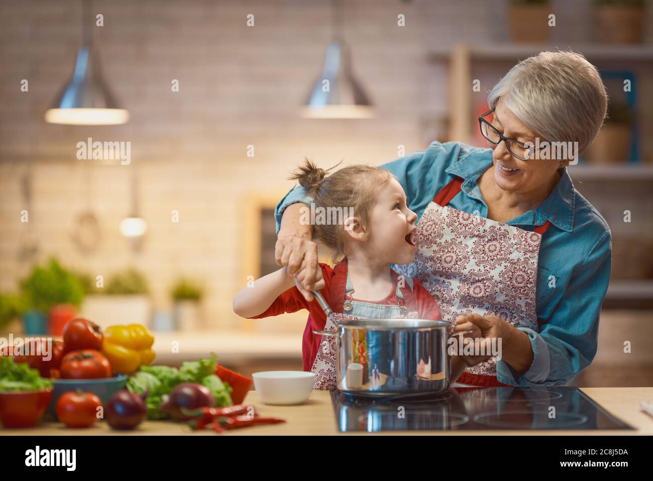 Healthy food at home. Happy family in the kitchen. Grandma and child ...