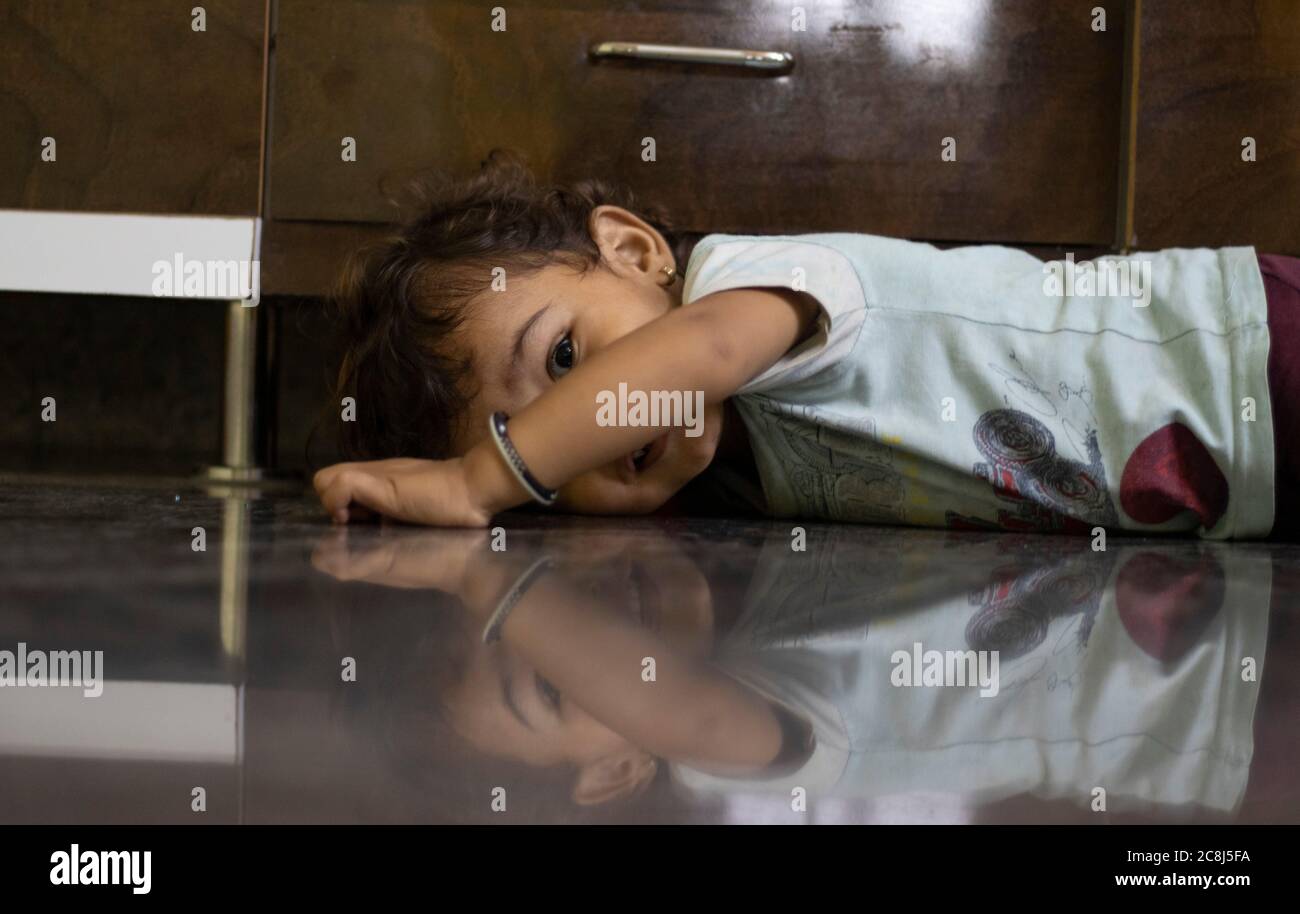 A child watching with an eye and his image formed on a marble stone ...