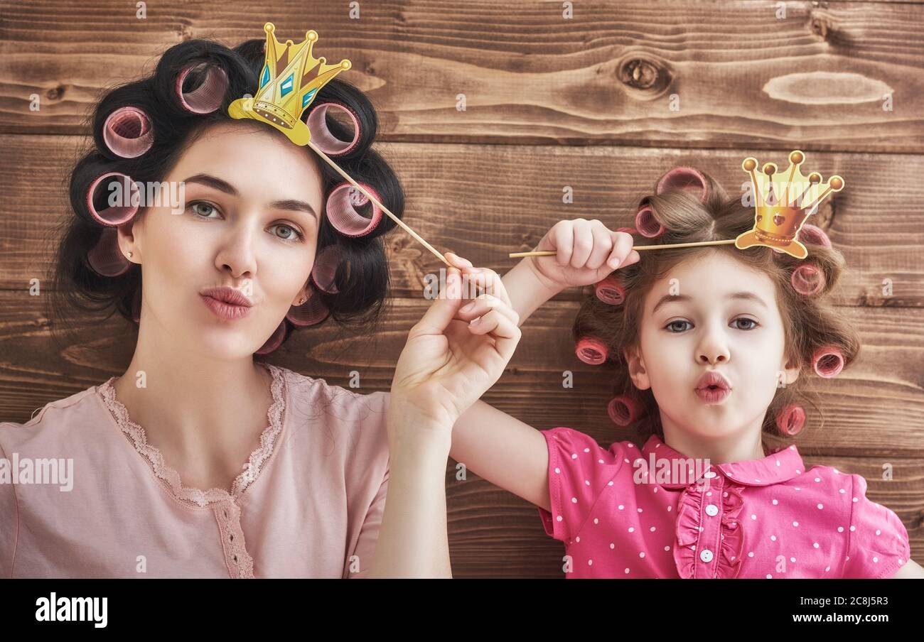 Funny family! Mother and her child daughter girl with a paper ...