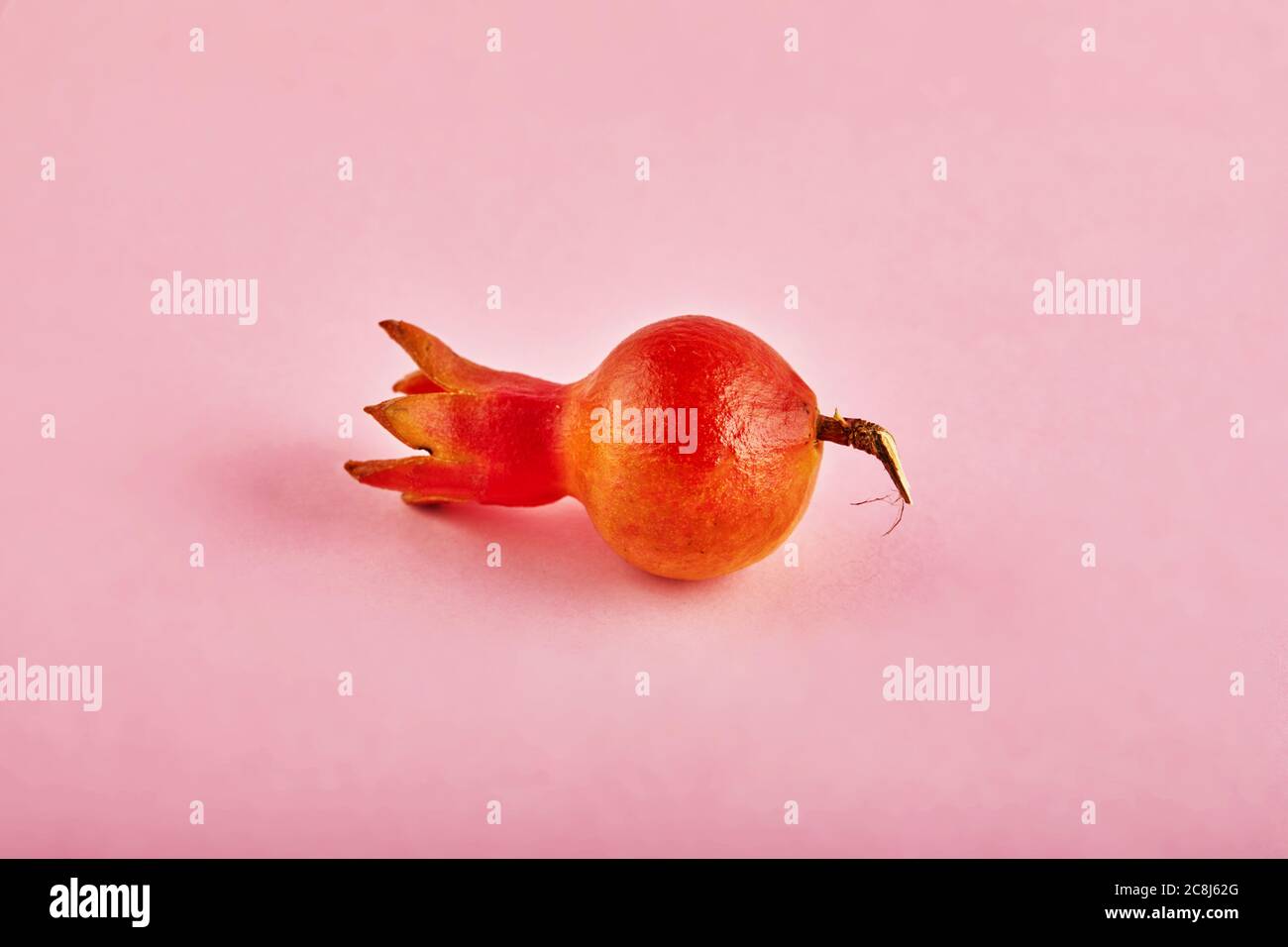 Mini pomegranate lying on a pink background with a shadow Stock Photo ...