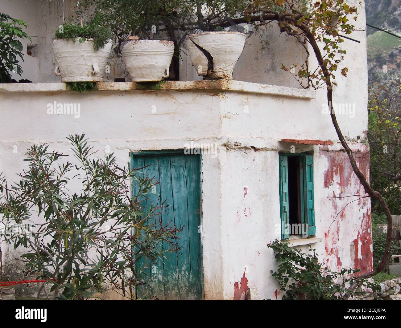 Cretan village view with pots Stock Photo - Alamy