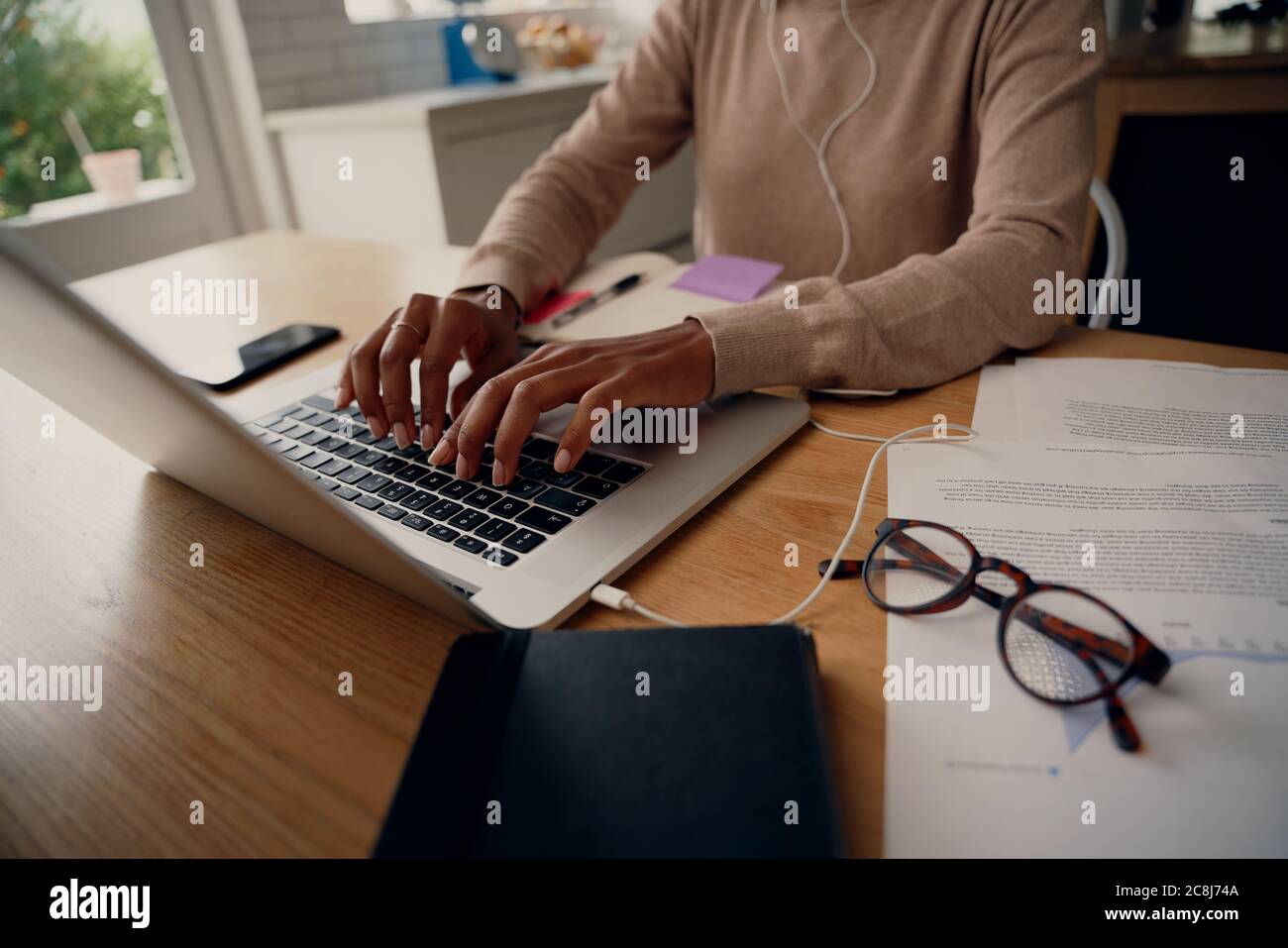 Close-up of busy female hand typing on keyboard while sitting at her ...
