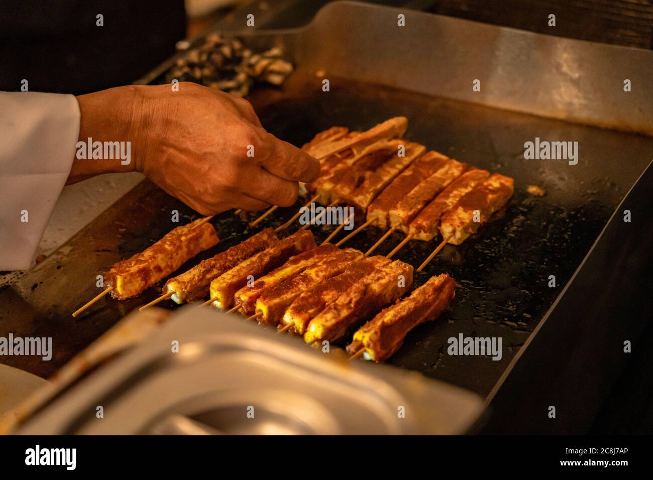 A chef cooking Paneer Satay on a restaurant griddle Stock Photo - Alamy