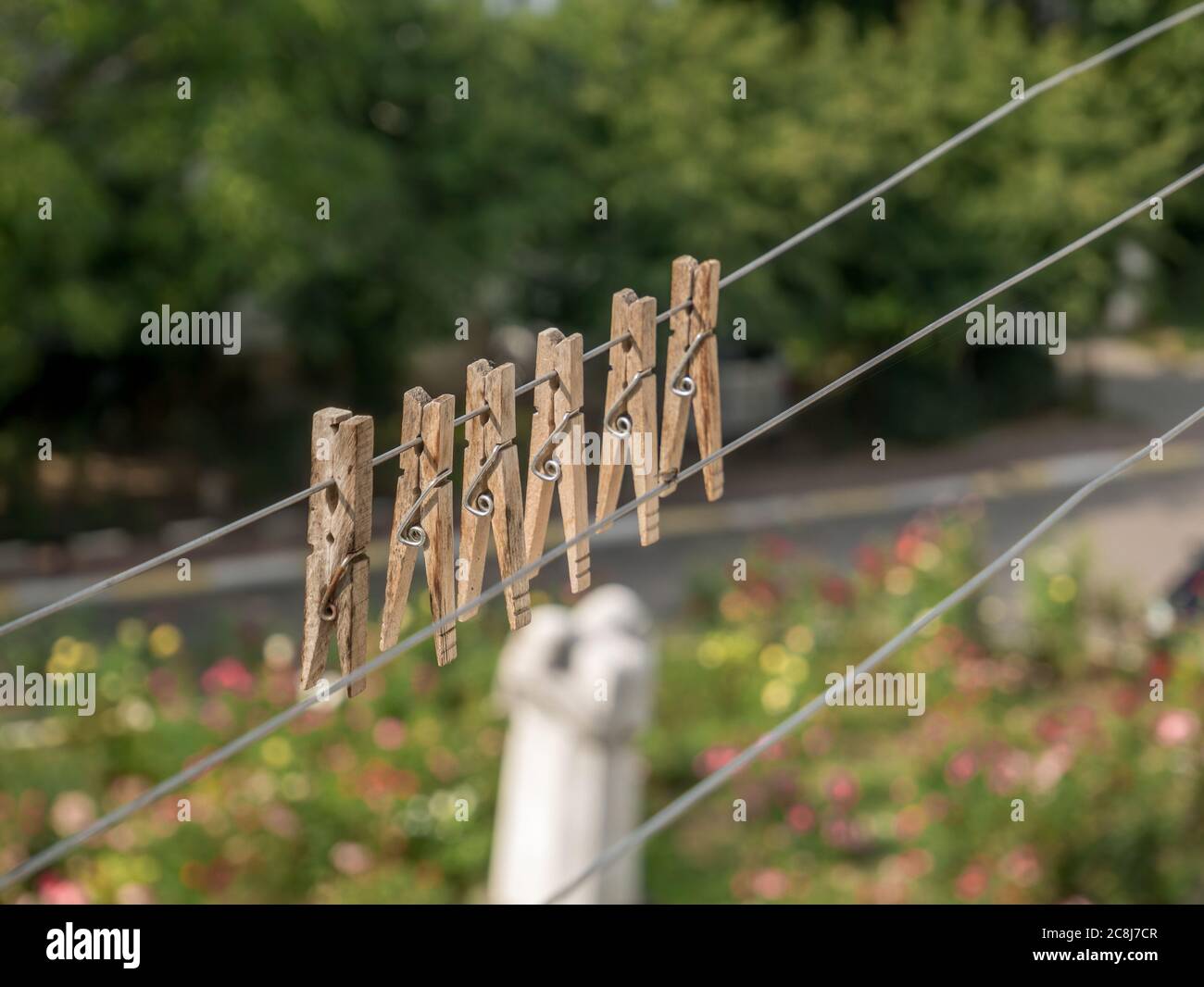 Old wooden cloth pins on cloth wire Stock Photo - Alamy