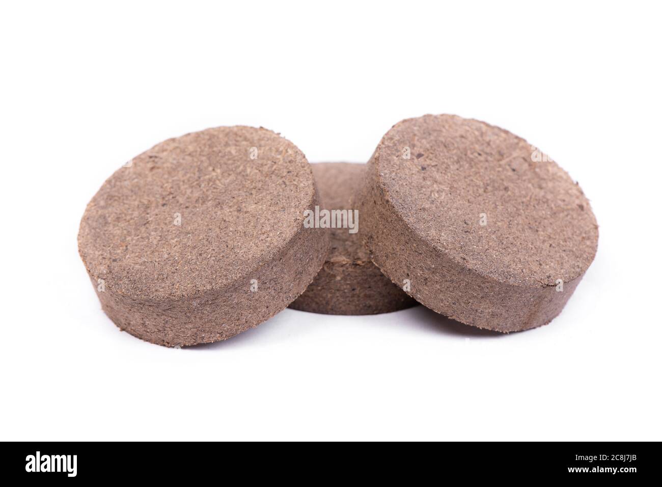 Dry peat pellets, compressed compost tablet isolated over the white ...