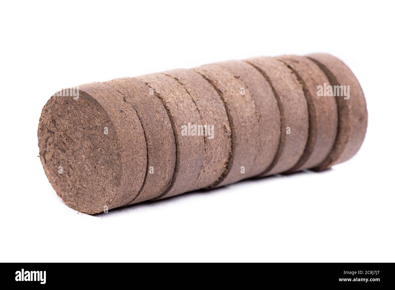 Dry peat pellets, compressed compost tablet isolated over the white ...