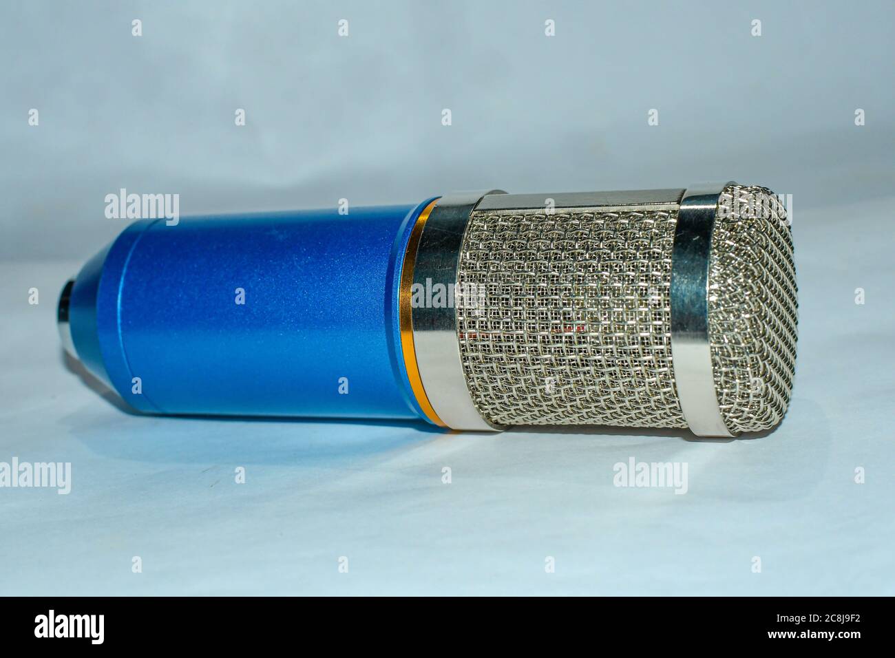 Blue and silver colour voice microphone on white background Stock Photo ...