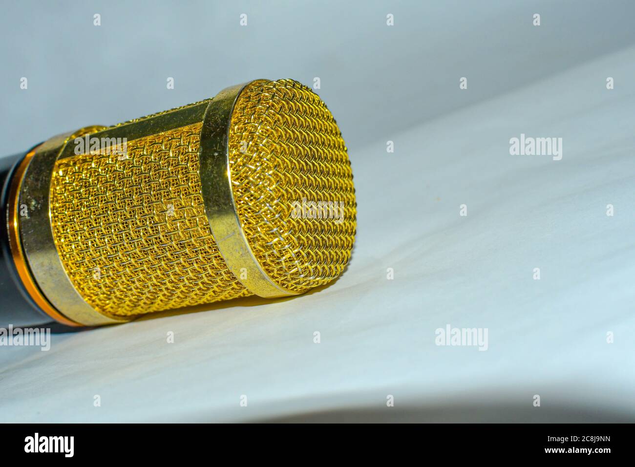 Golden colour microphone close up view on white background Stock Photo ...