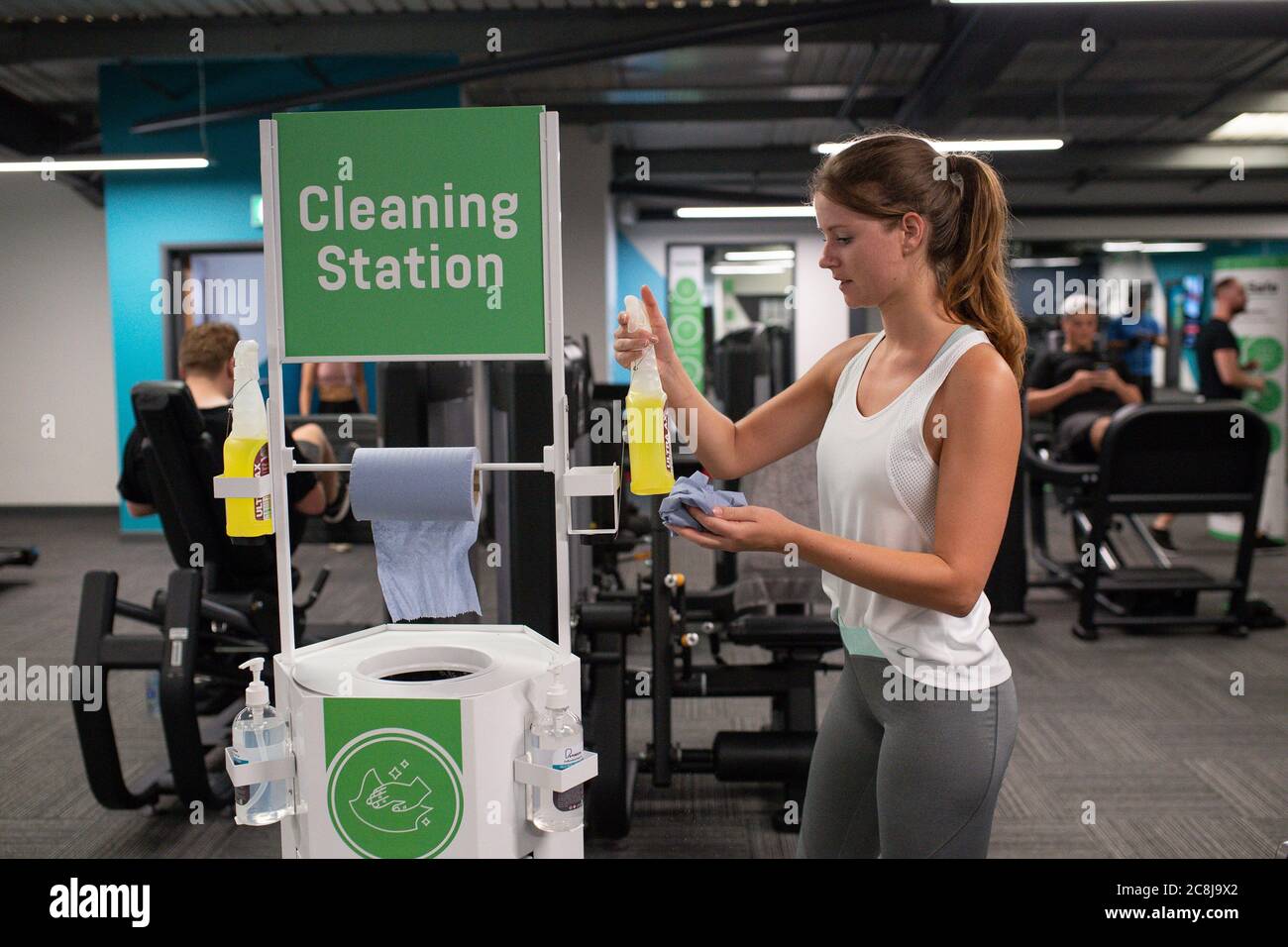 A gym member uses the cleaning station at PureGym in Leamington Spa ...