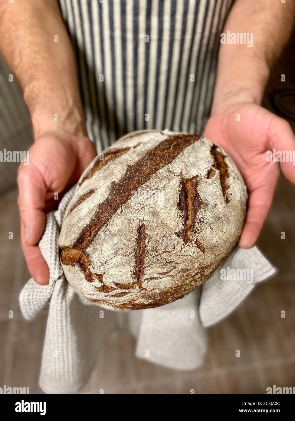 Holding a loaf of bread in his hands hi-res stock photography and ...