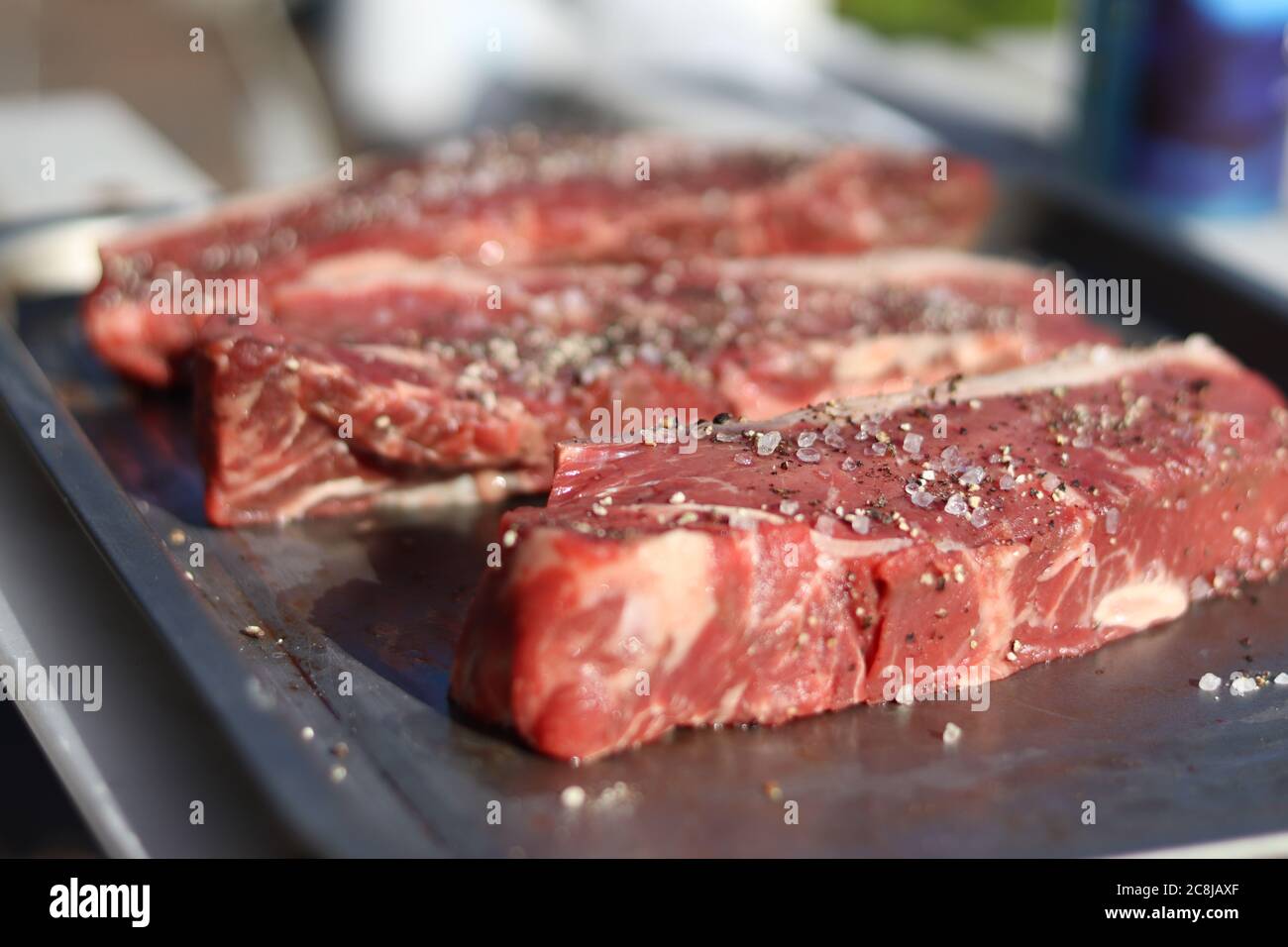 Prime steak cuts seasoned and ready for searing Stock Photo - Alamy