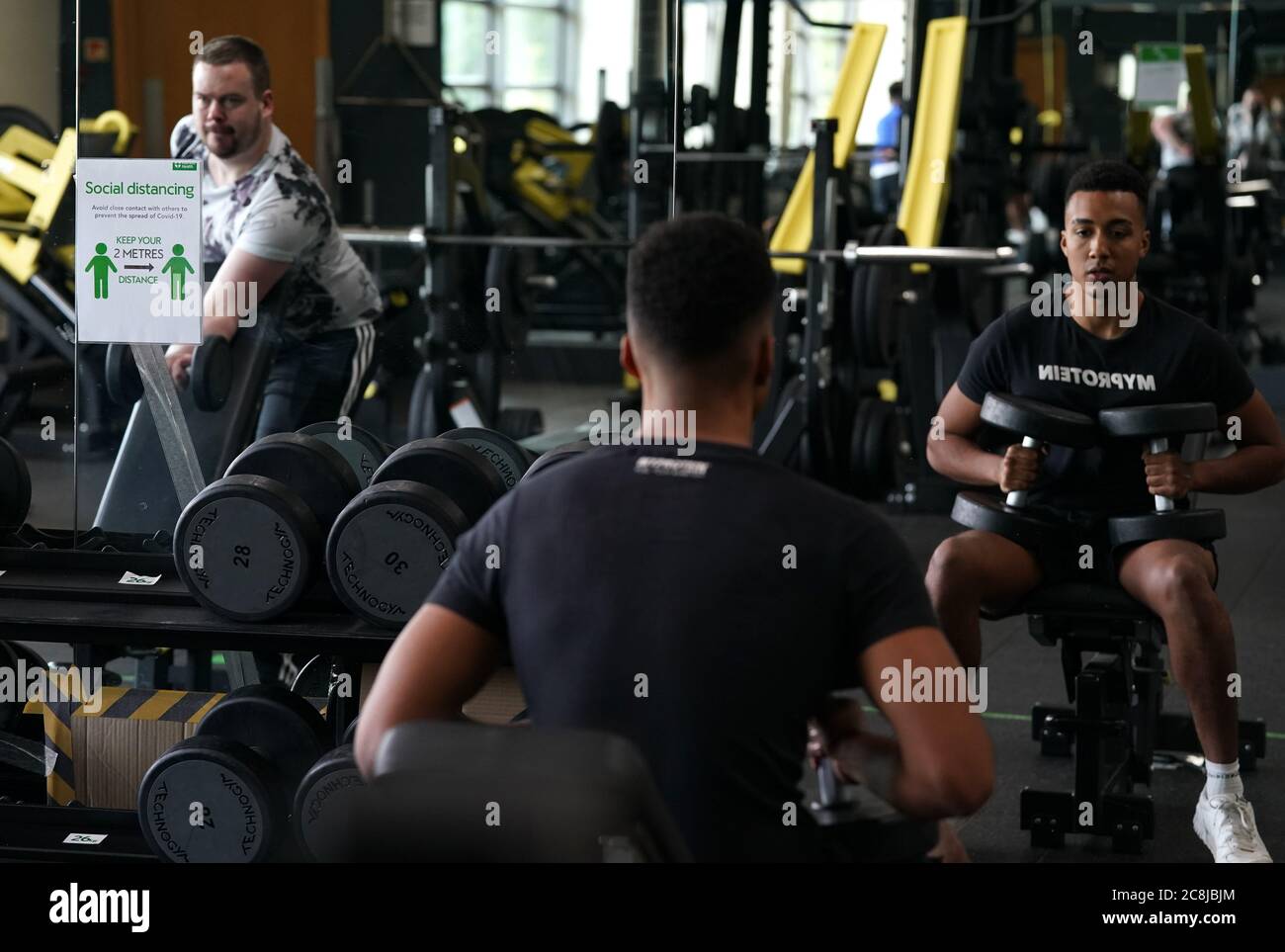 Gym members exercise at Nuffield Health Sunbury gym as indoor gyms ...