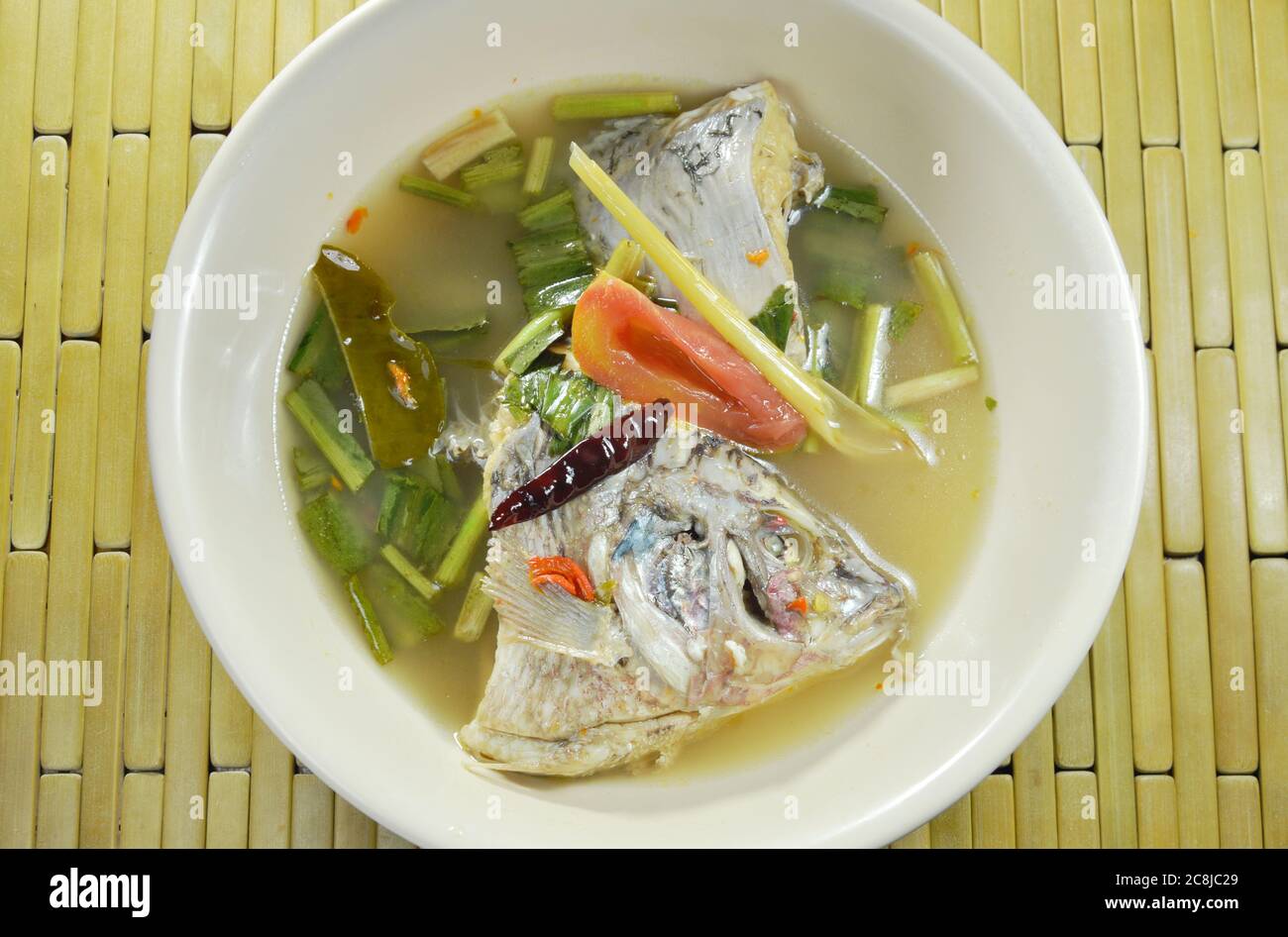 spicy boiled mango fish head in Tom Yum soup on bowl Stock Photo - Alamy