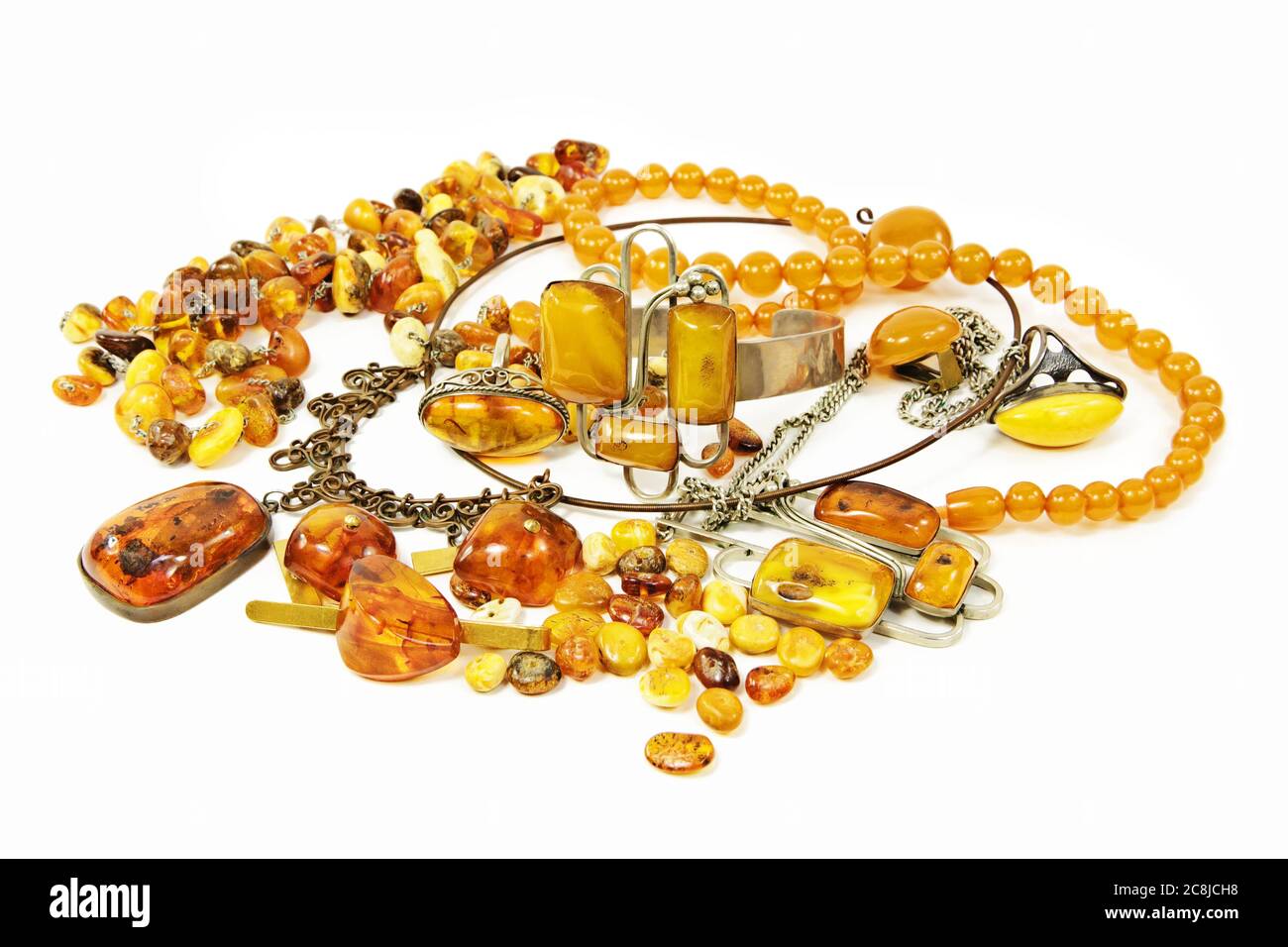 Various amber jewelry and other amber goods isolated on white ...
