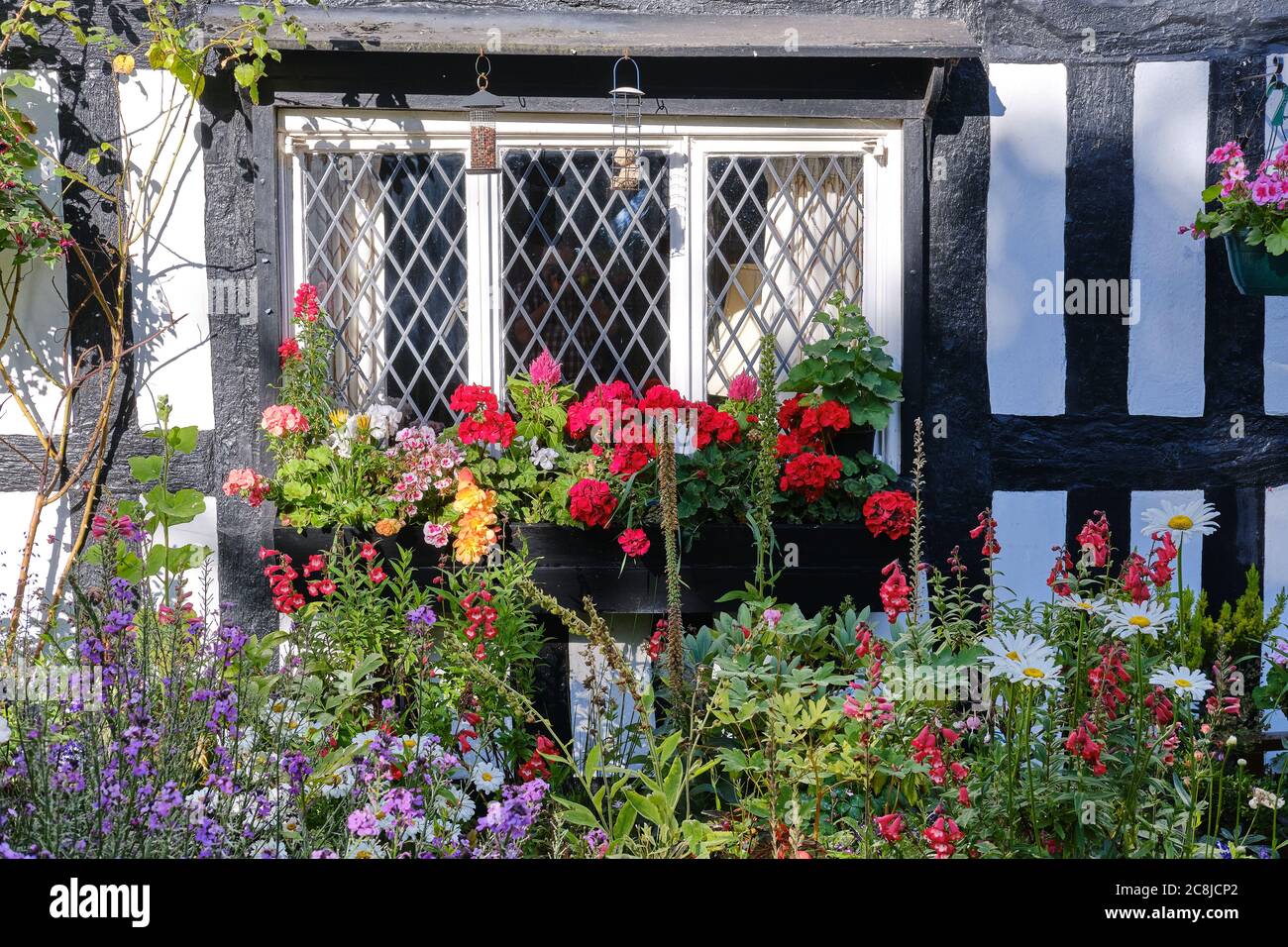colourful flowers in the garden of a timber-framed cottage Stock Photo ...