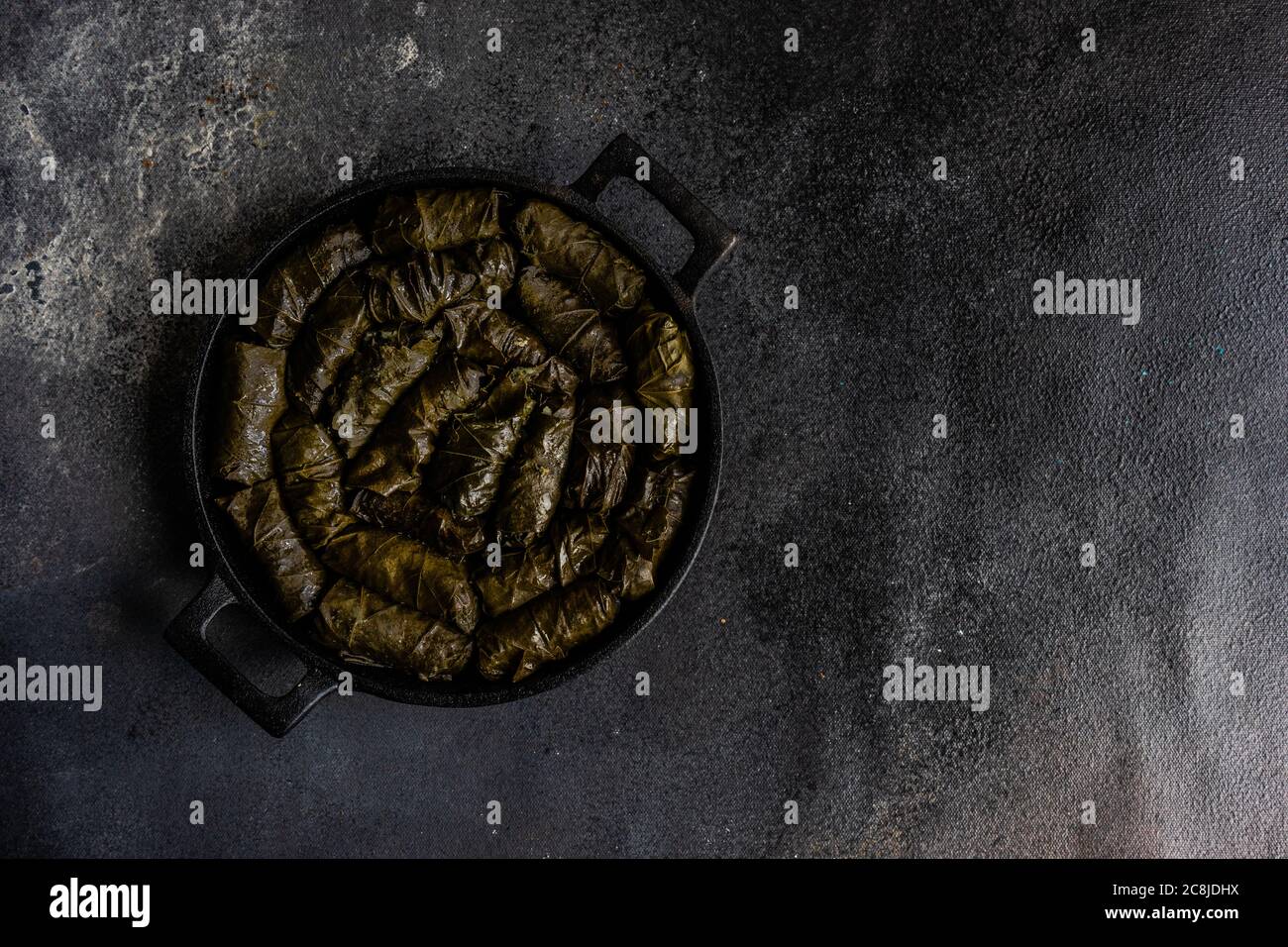 Traditional georgian tolma in vine leaves on rustic background with ...