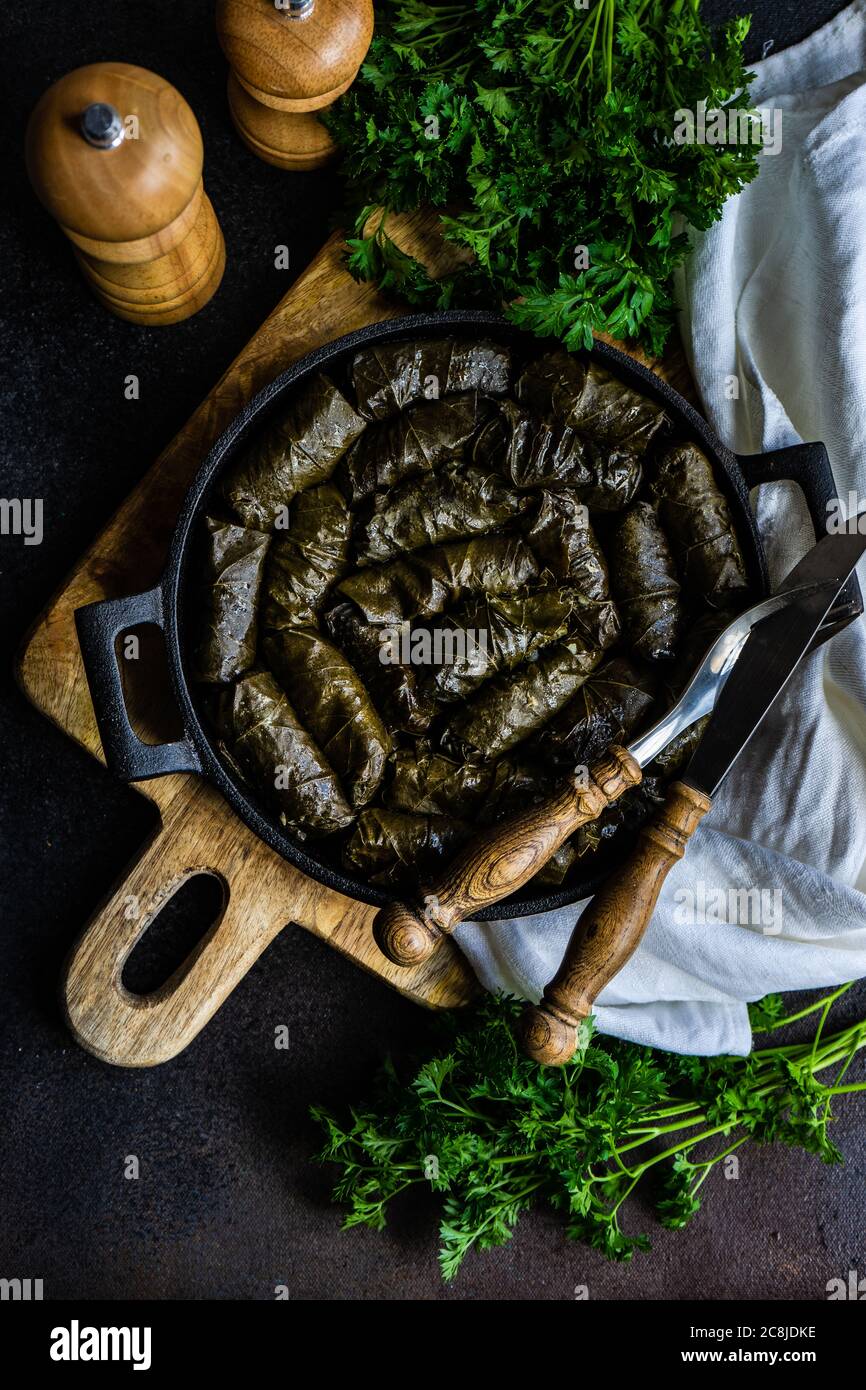 Traditional georgian tolma in vine leaves on rustic background with ...