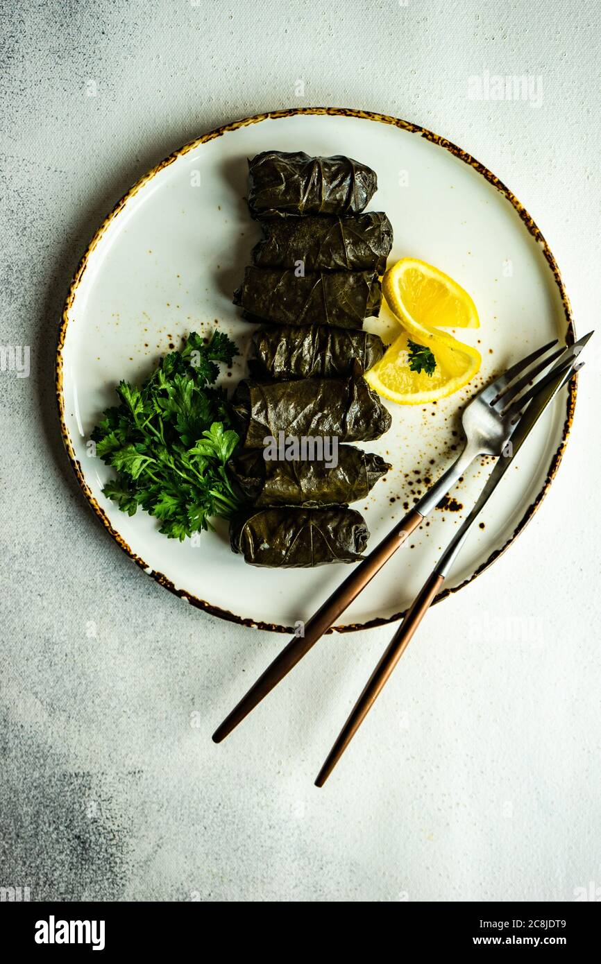 Traditional georgian tolma in vine leaves on rustic background with ...