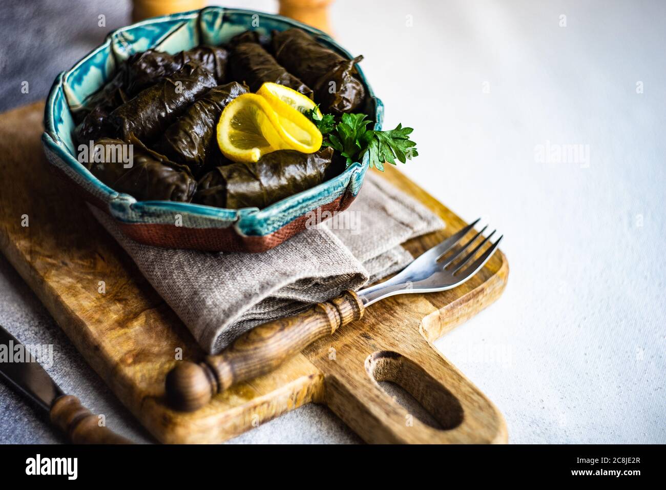 Traditional georgian tolma in vine leaves on rustic background with ...