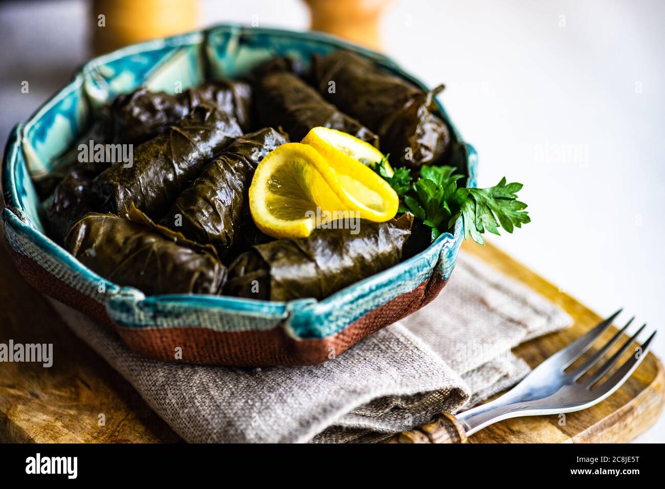 Traditional georgian tolma in vine leaves on rustic background with ...
