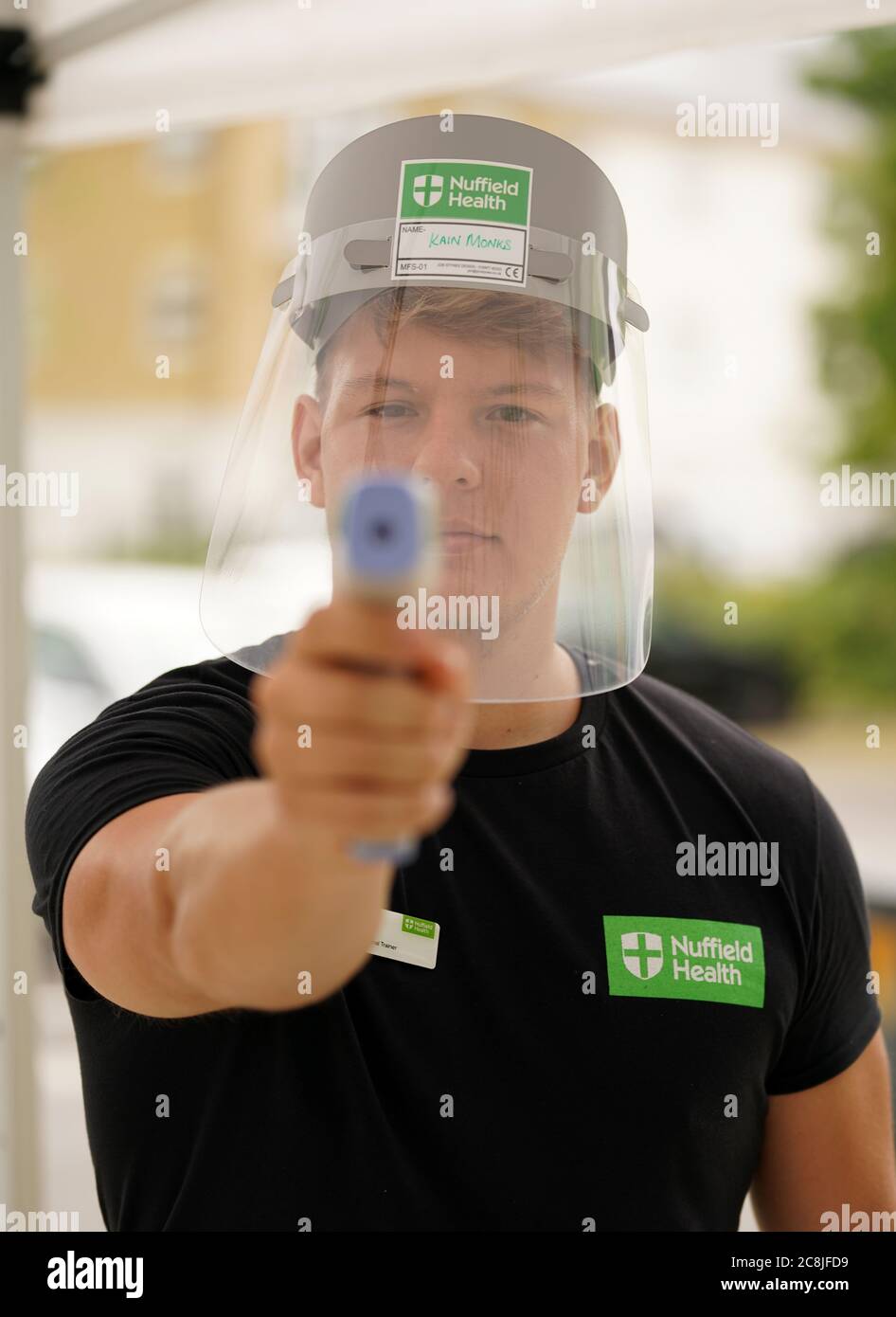 A staff member prepares to check a gym members temperature at Nuffield ...