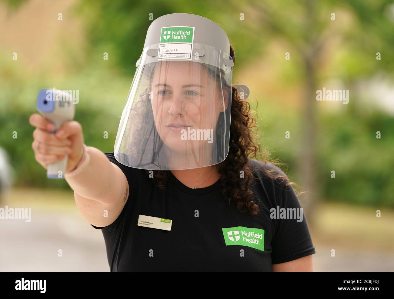 A staff member prepares to check a gym members temperature at Nuffield ...