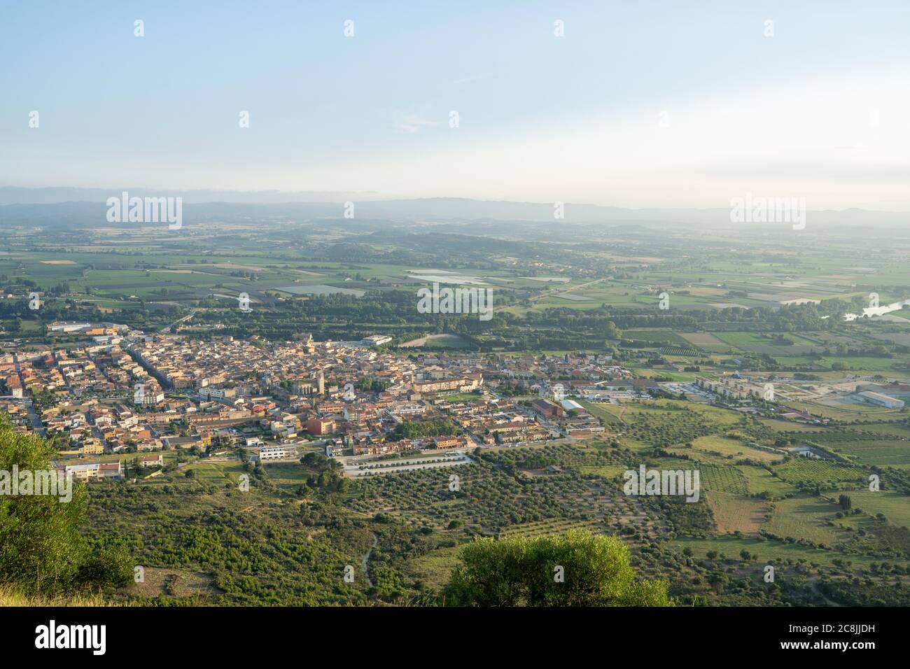 Aerial view of a village in the middle of fields and the unfocused ...