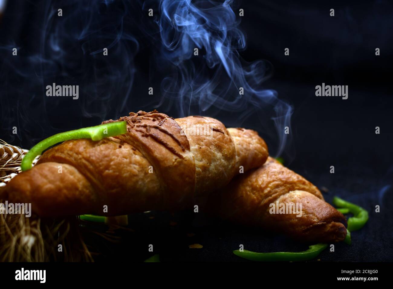 hot chilli bread with smoke on black background.Food background and ...
