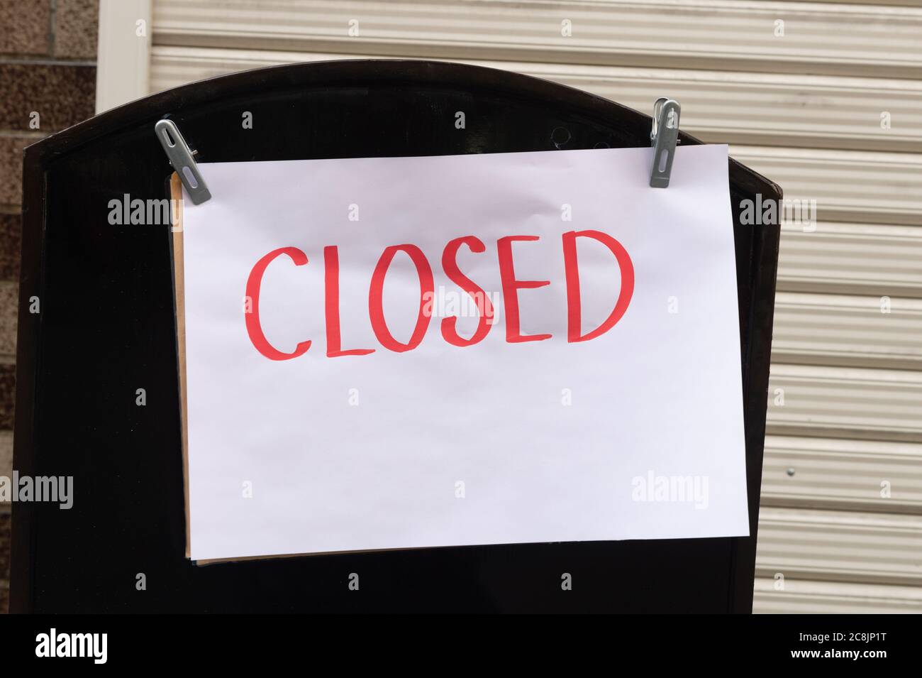 sorry we are closed sign hanging outside a restaurant, store, office or ...