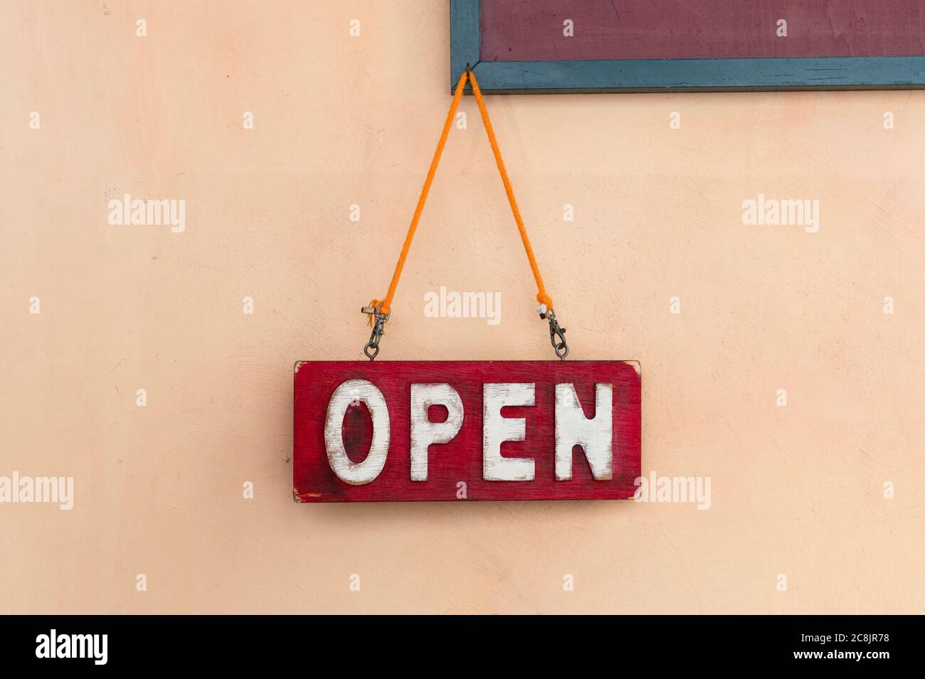 Open sign hanging on wooden wall in restaurant Stock Photo - Alamy