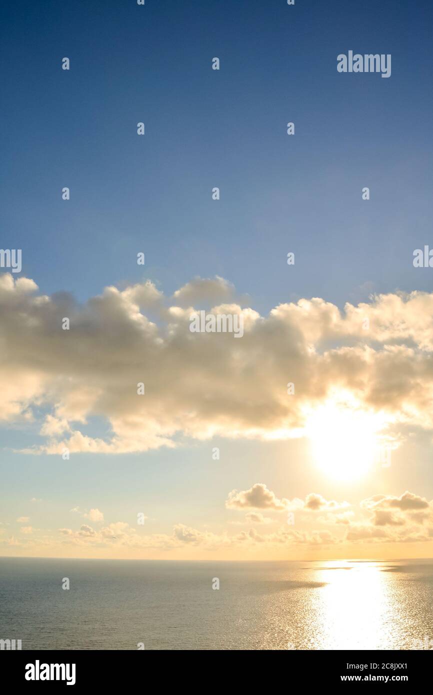 Photo Picture of The Sun Setting in the Sea Stock Photo - Alamy