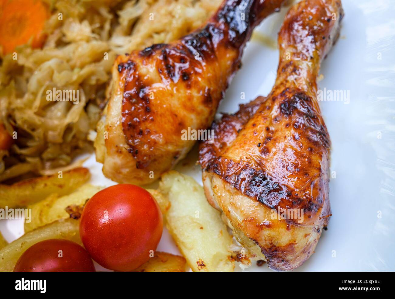 Roasted chicken leg with cherry tomato.Top view Stock Photo - Alamy