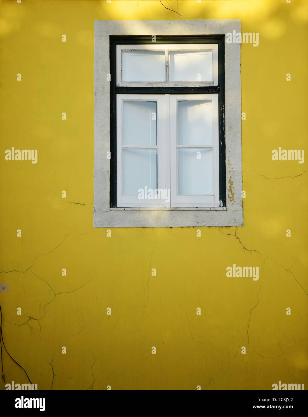 Window on a yellow building Stock Photo - Alamy
