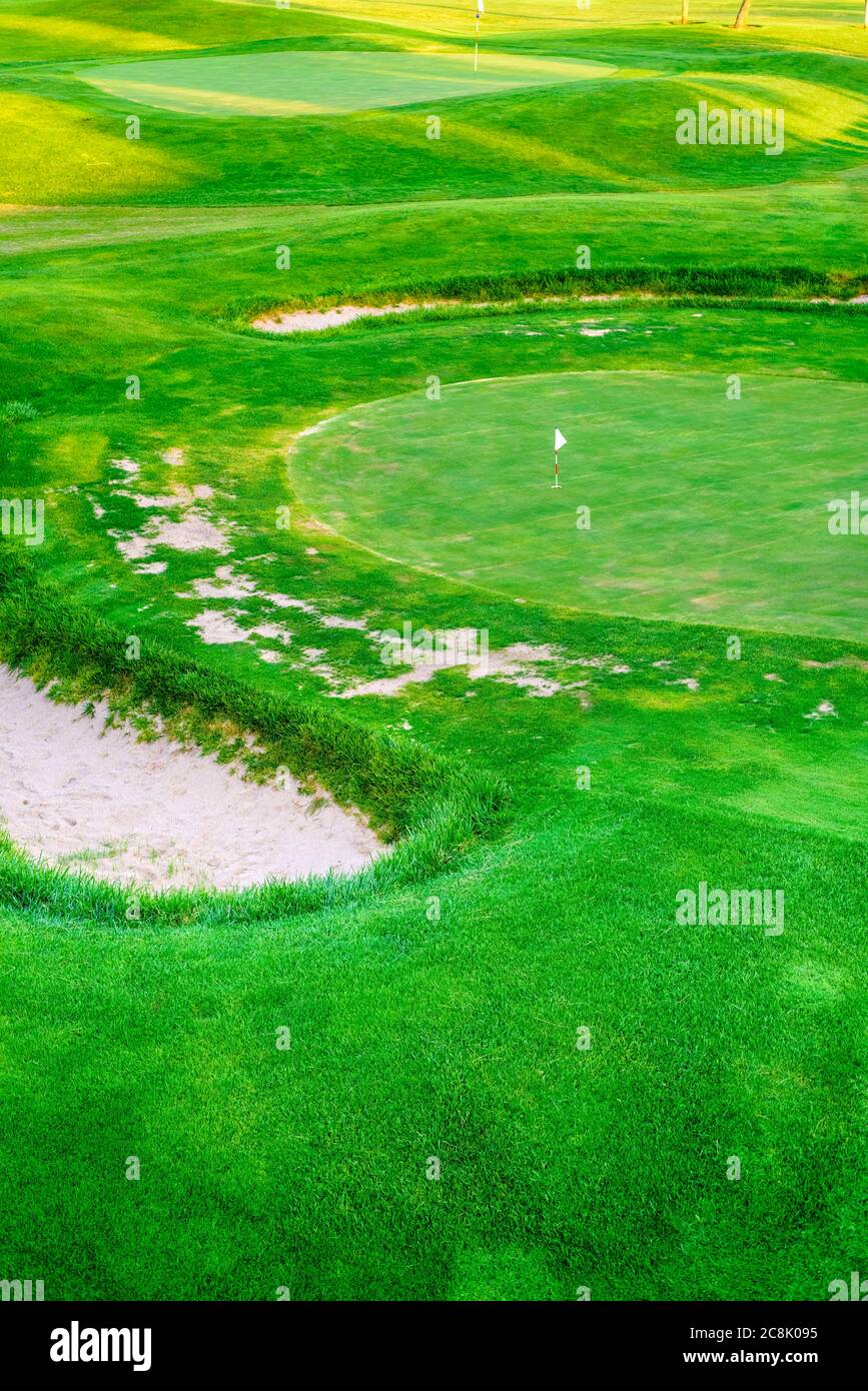An empty golf course green a little run down Stock Photo - Alamy