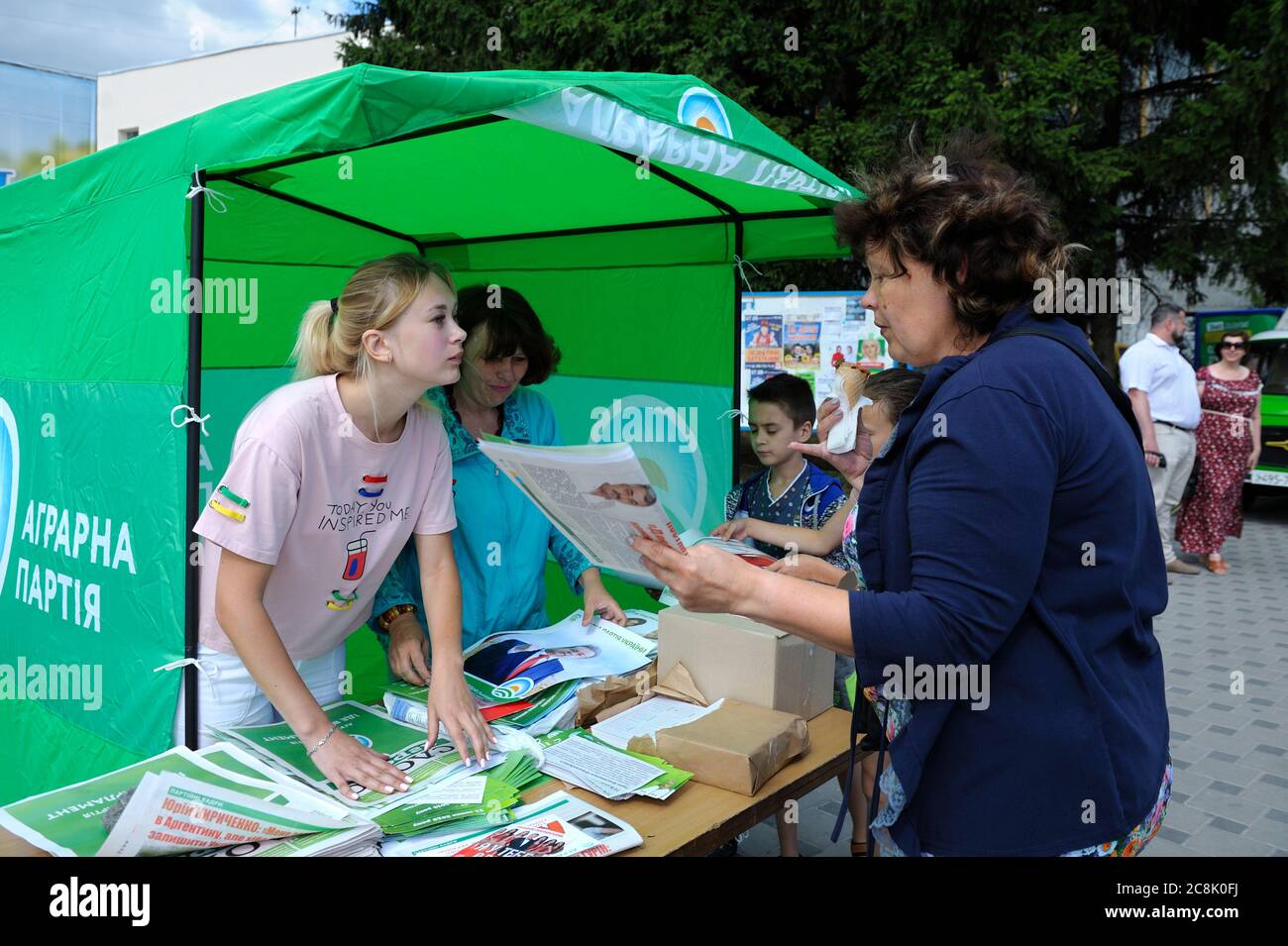 Election campaign. Girl, street campaigner, giving leaflets to woman ...