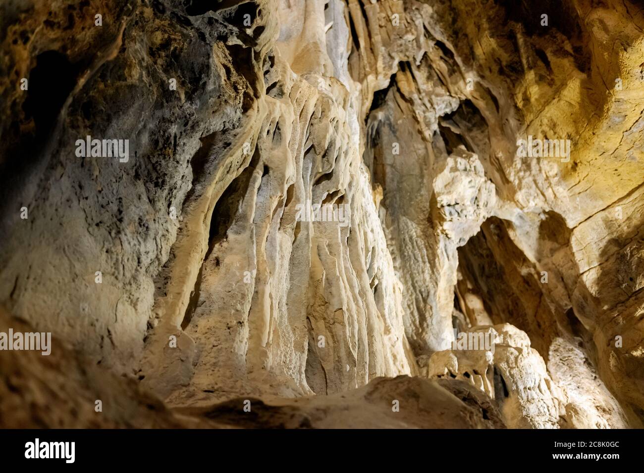 Stalactite and stalagmite formations on the rocky walls of a large ...