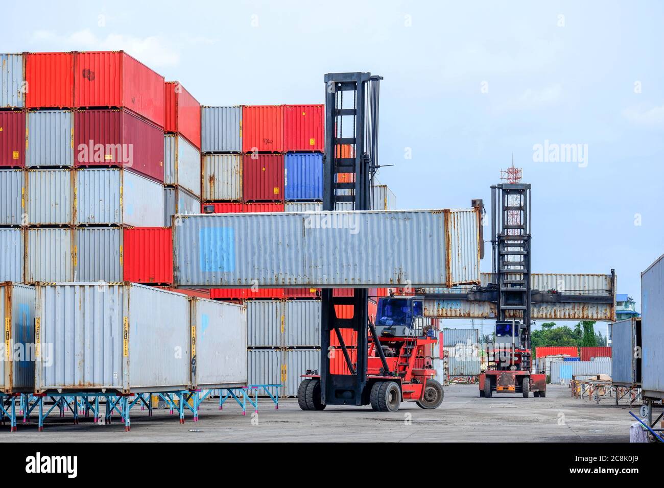 Container handlers in the harbor Stock Photo - Alamy