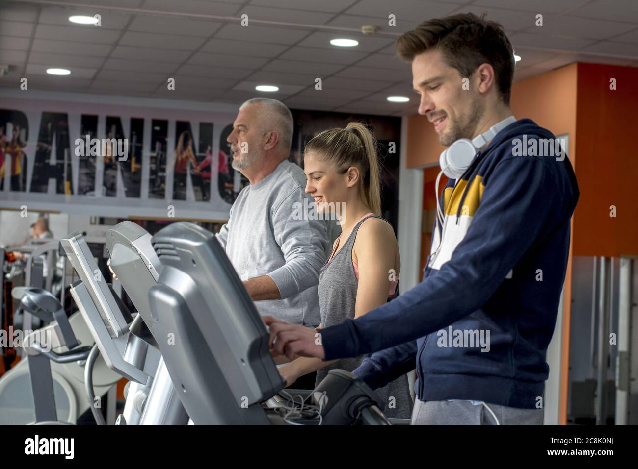 People exercising in a gym indoors and the sunlight falls out of the ...