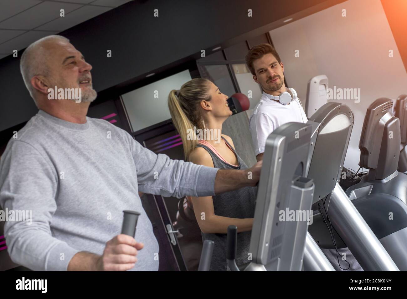 People exercising in a gym indoors and the sunlight falls out of the ...