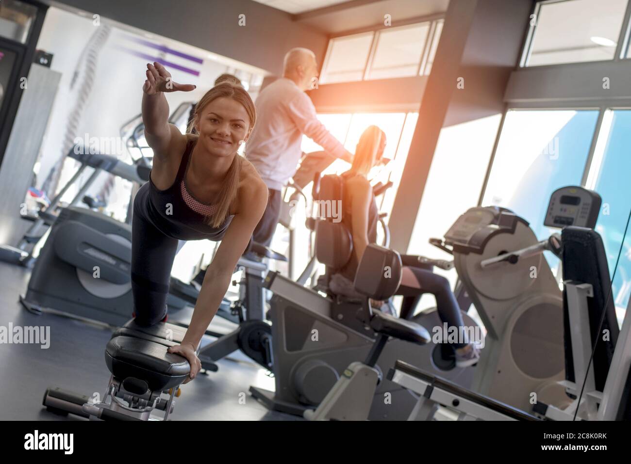 People exercising in a gym indoors and the sunlight falls out of the ...
